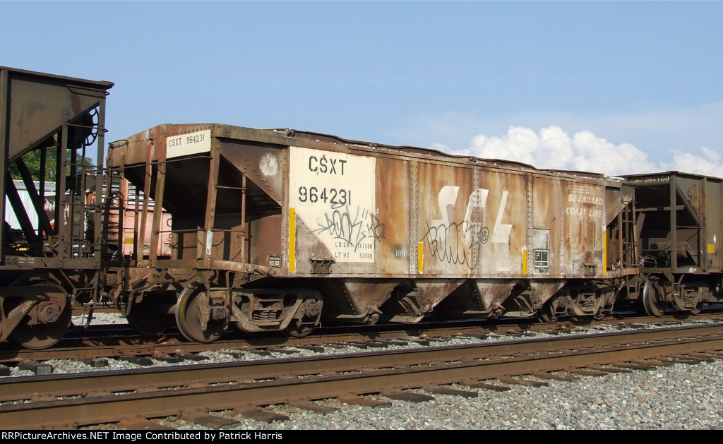 CSXT 964231 X-SCL U-10 phosphate covered hopper converted to MOW ballast service on a siding in ...